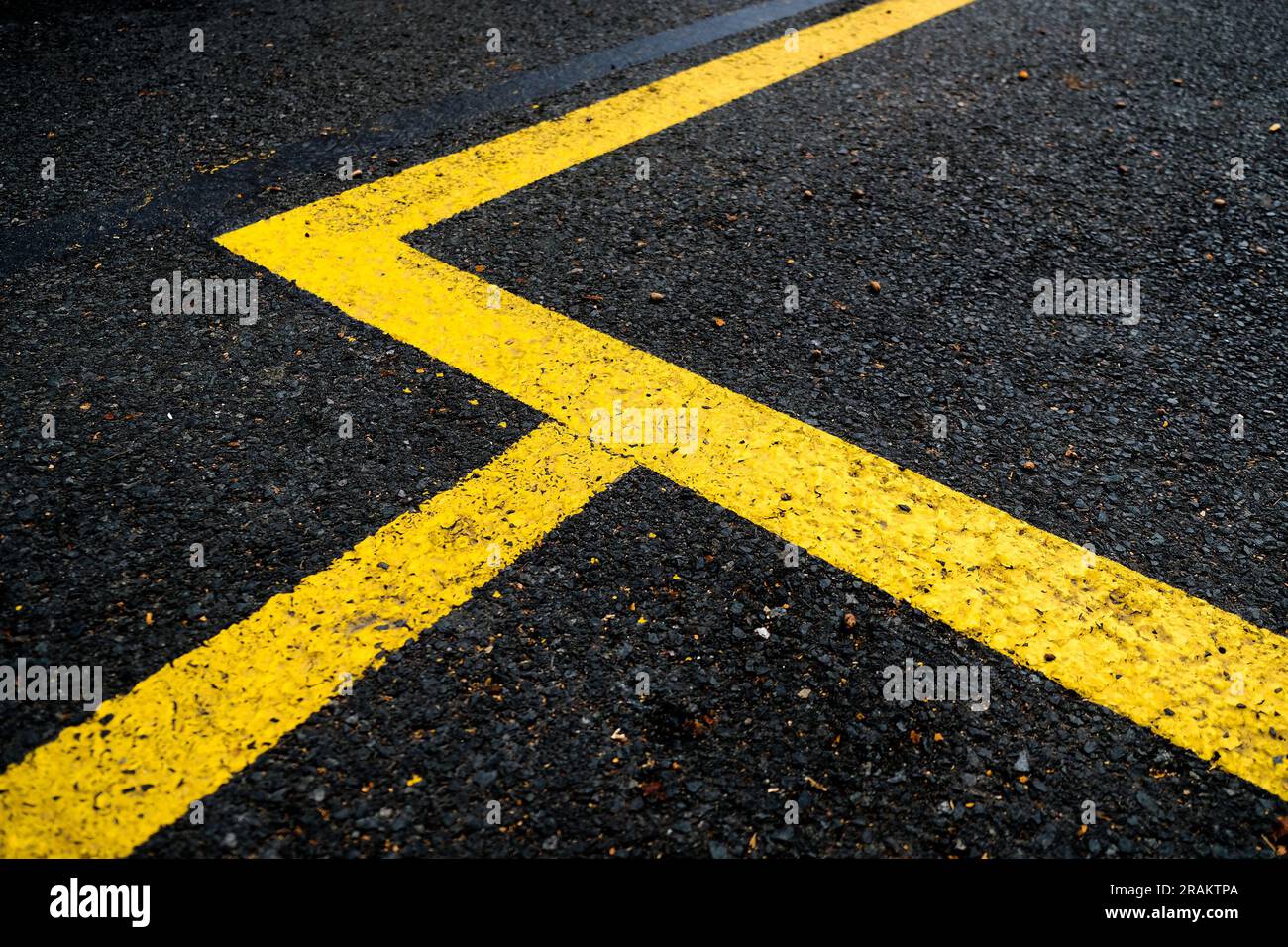 Vivid yellow lines on black surface, road signage abstract elements ...