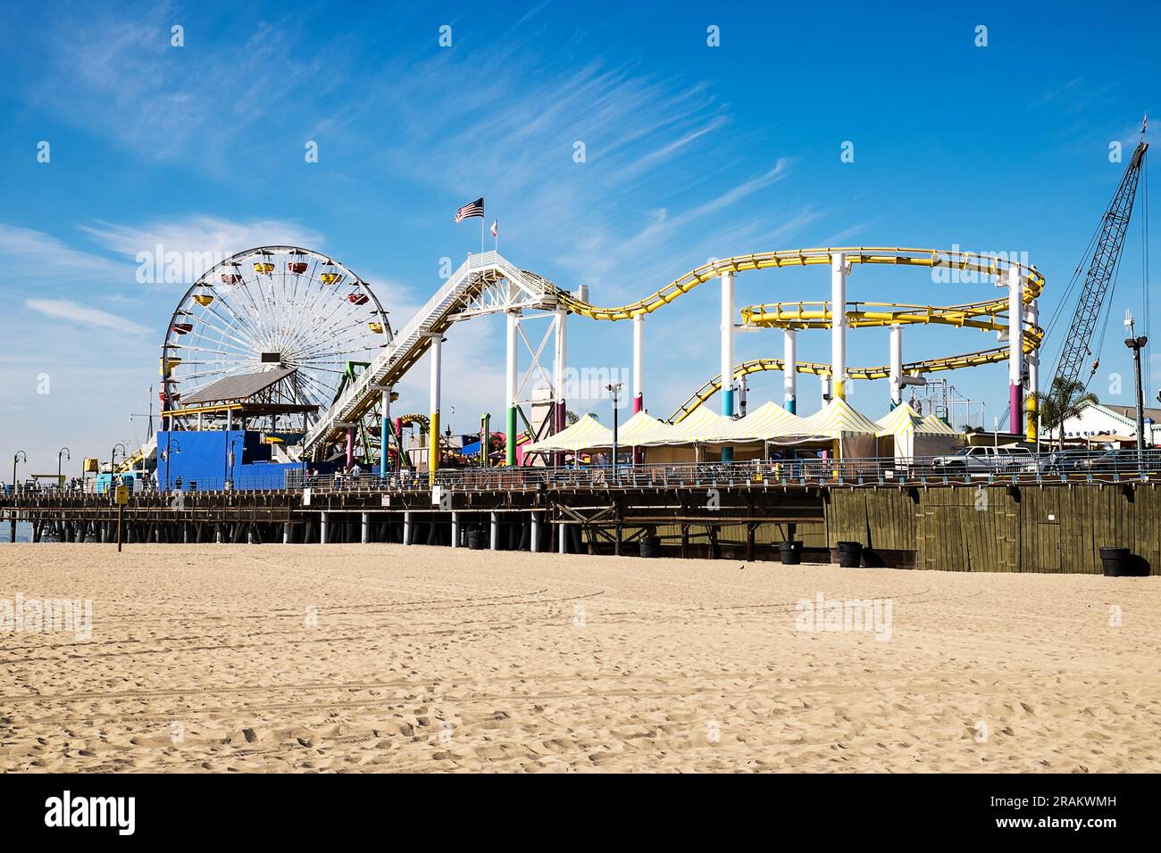 A view of the ferris wheel and roller coaster rides at the amusement ...