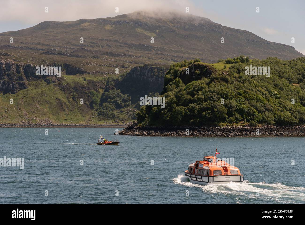 Portree, Isle of Skye, Scotland, UK. 5 June 2023. Cruise ship tender underway on Loch Portree ...