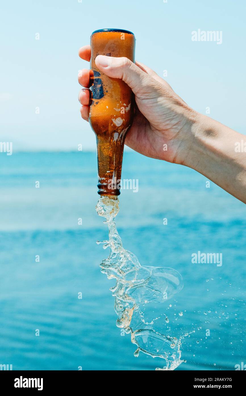 Tourist throwing away empty bottle hi-res stock photography and images ...