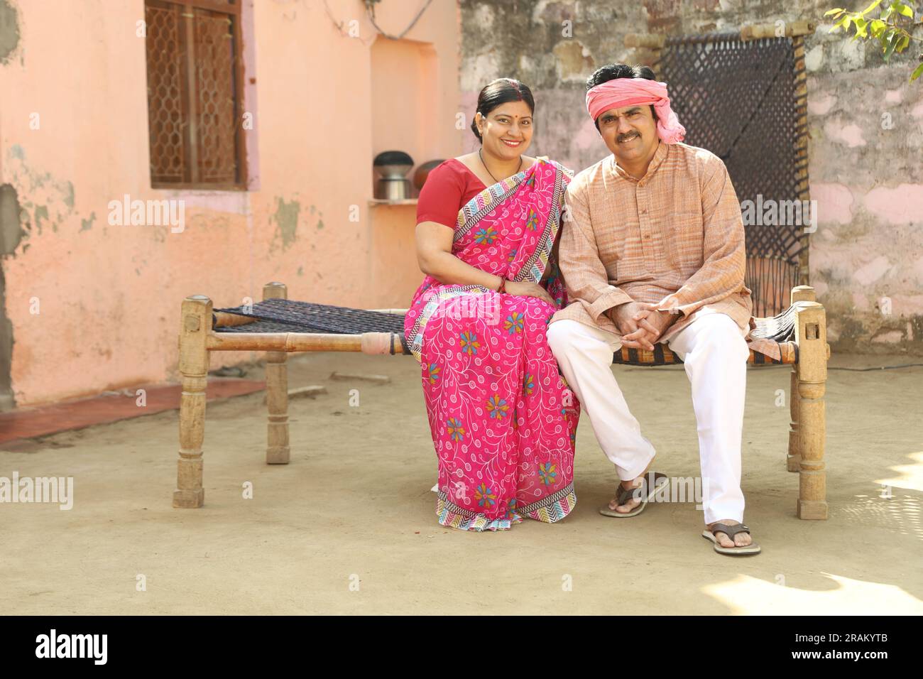 Indian rural farmer couple sitting outdoors together. Indian villager's ...