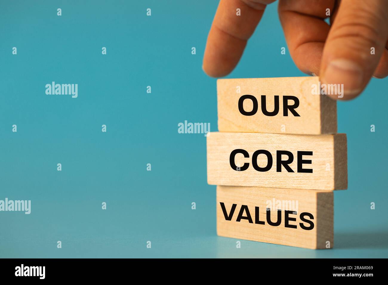 our company core values, Concept, Hand arranging wooden blocks with ...