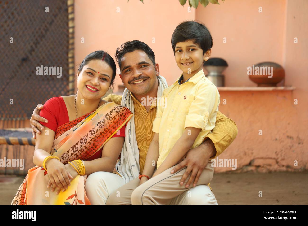 Portrait of Indian rural farmer family of father mother and son sitting ...