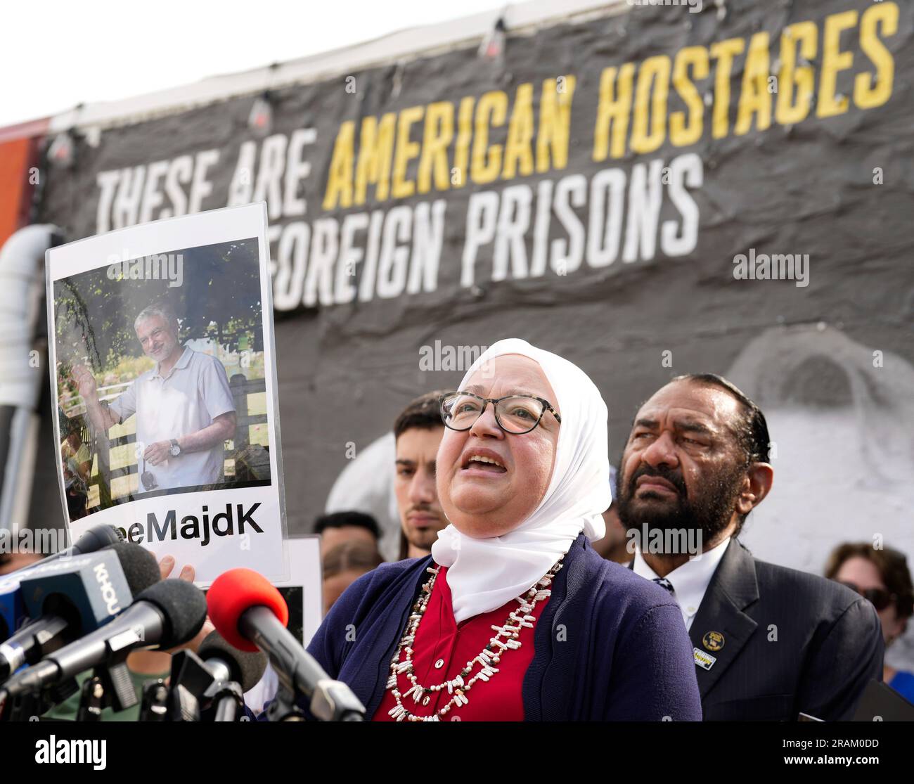 U.S. Congressman Al Green, right, listens as Samar Hamwi, sister of ...