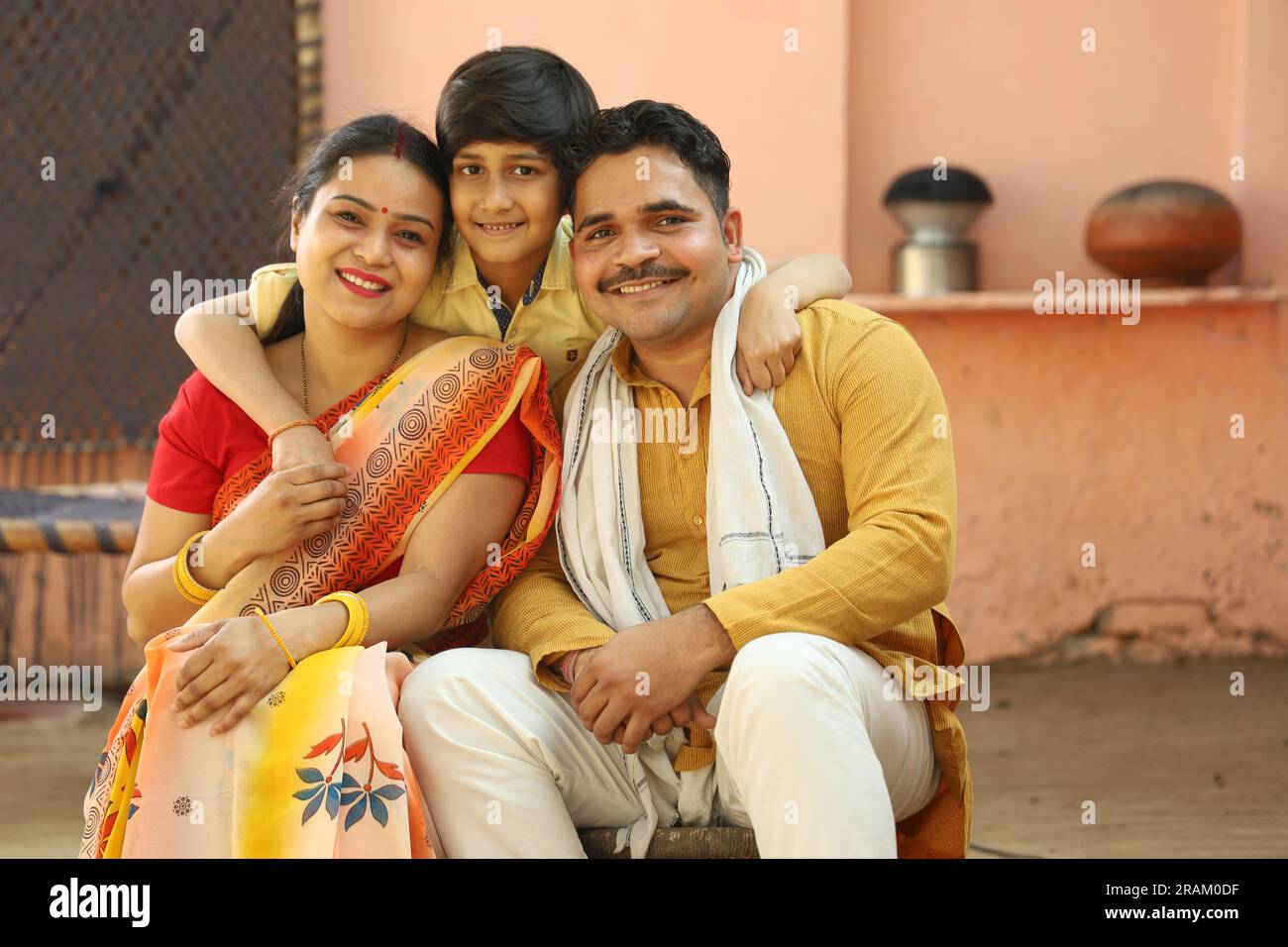 Portrait of Indian rural farmer family of father mother and son sitting ...