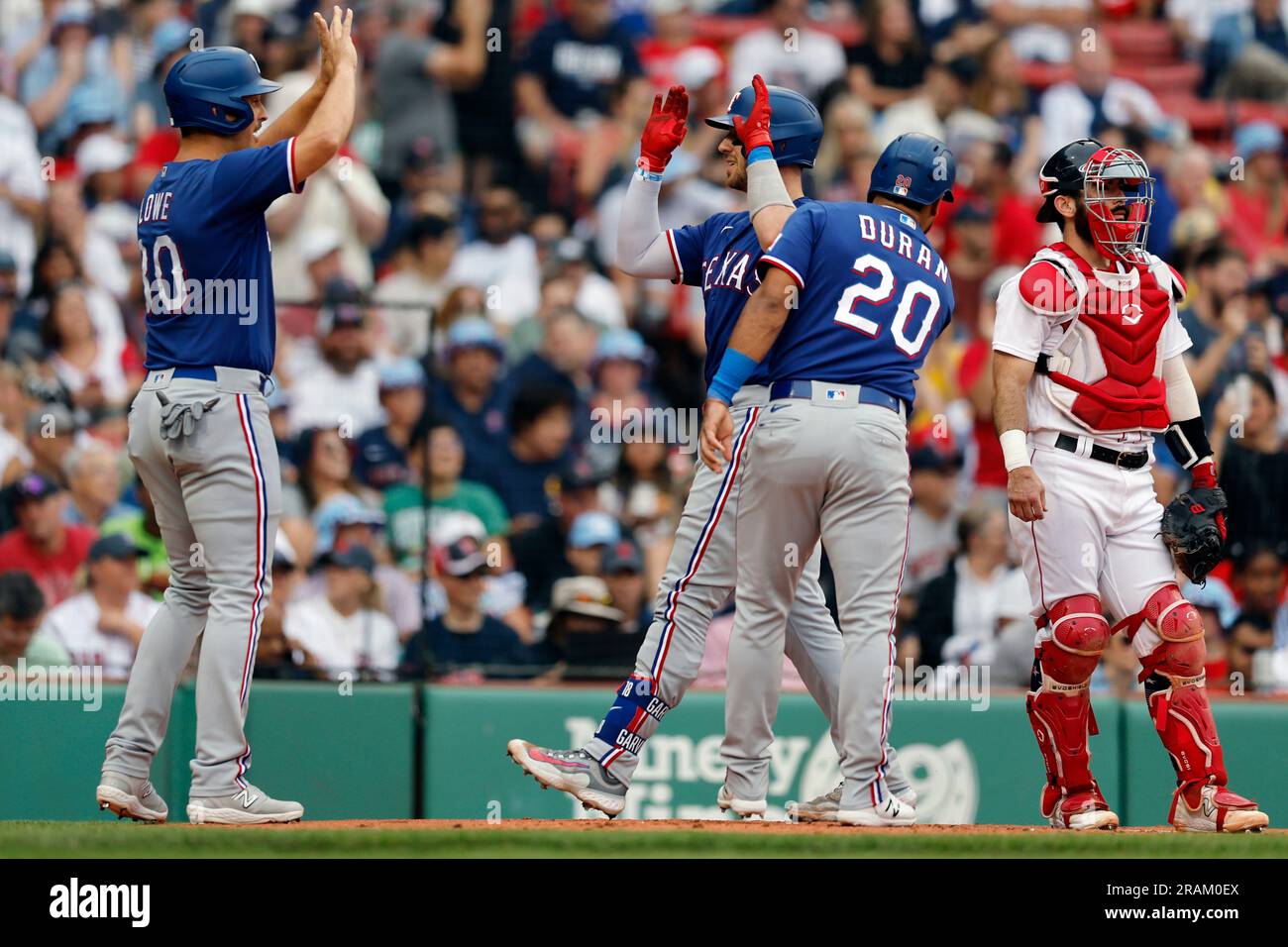 Texas Rangers' Mitch Garver, center left, celebrates his three-run home ...