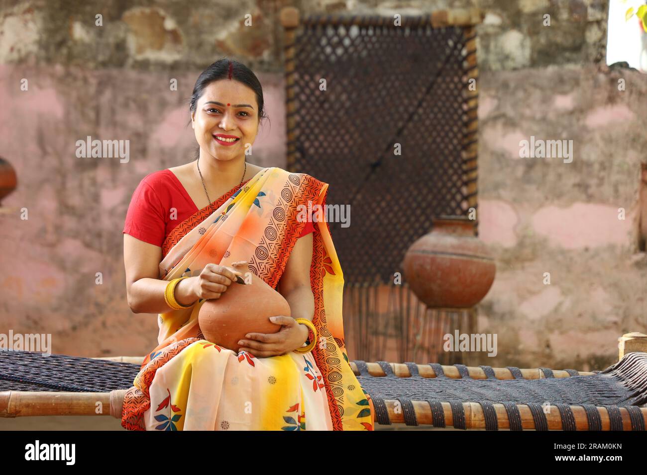 Happy rural Indian women in saree with the Piggy Bank in hand ...