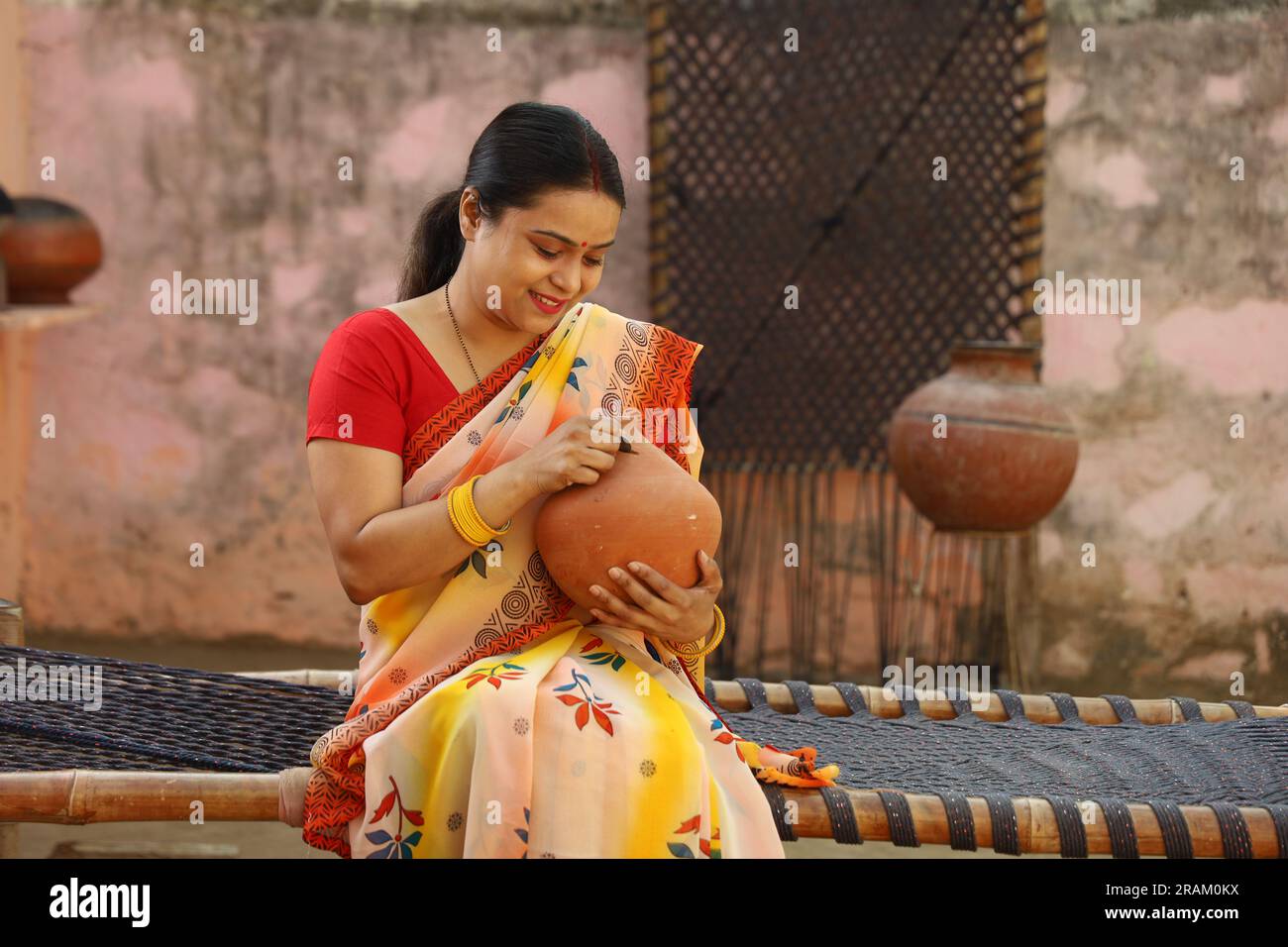 Happy rural Indian women in saree with the Piggy Bank in hand ...