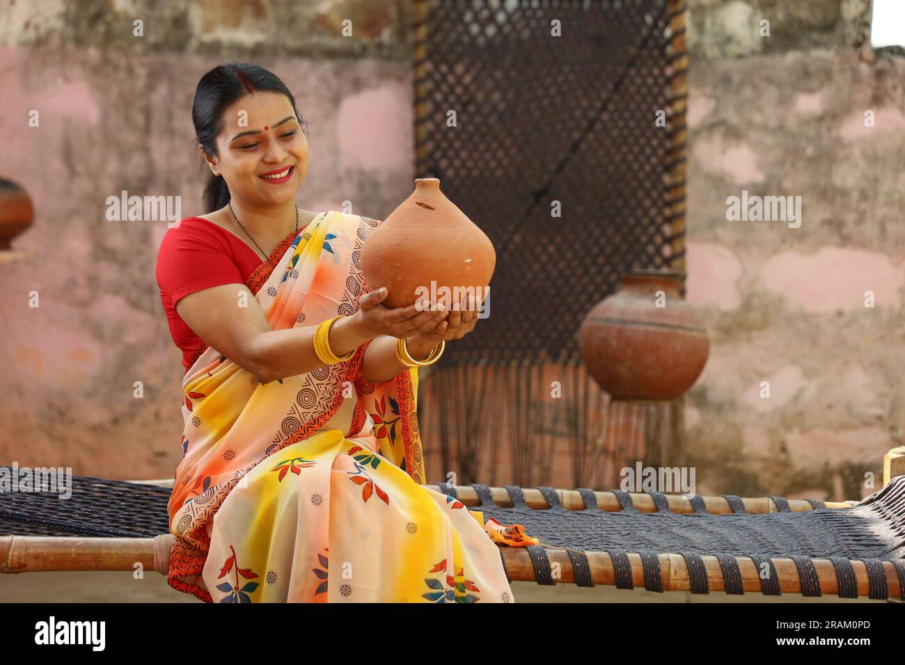 Happy rural Indian women in saree with the Piggy Bank in hand ...