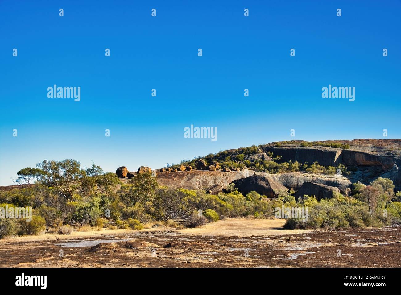 Eroded rocks and boulders with stunted outback vegetation in Sandford ...