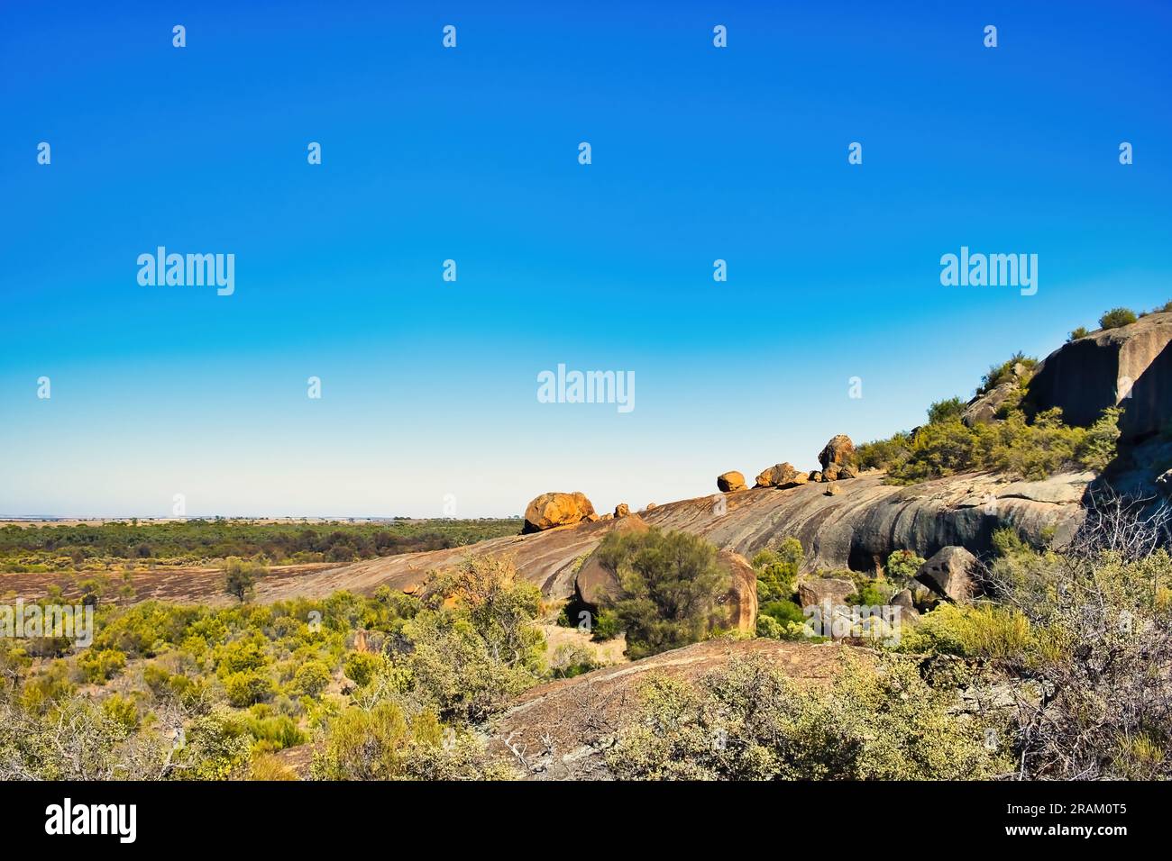 Eroded rocks and boulders with stunted outback vegetation in Sandford ...