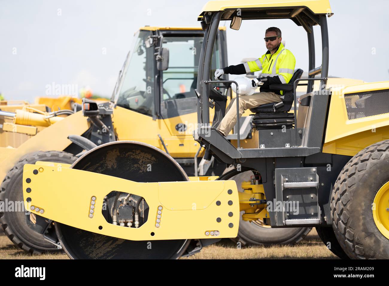 construction machinery worker at roller. machinery in a manufacturing ...