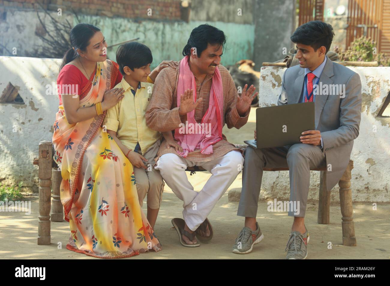 Happy Indian village family sitting with the banker or financial ...