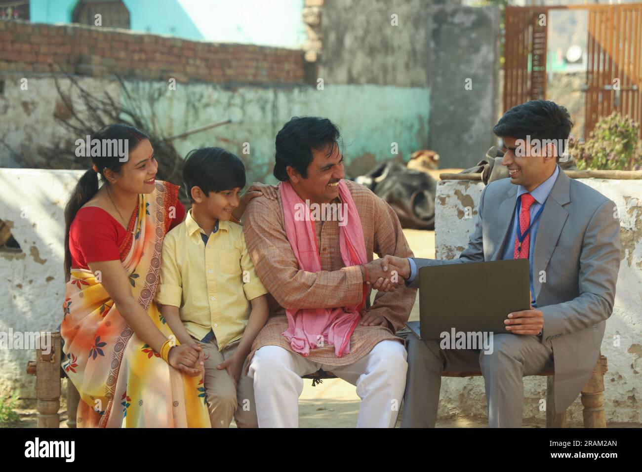 Happy Indian village family sitting with the banker or financial ...