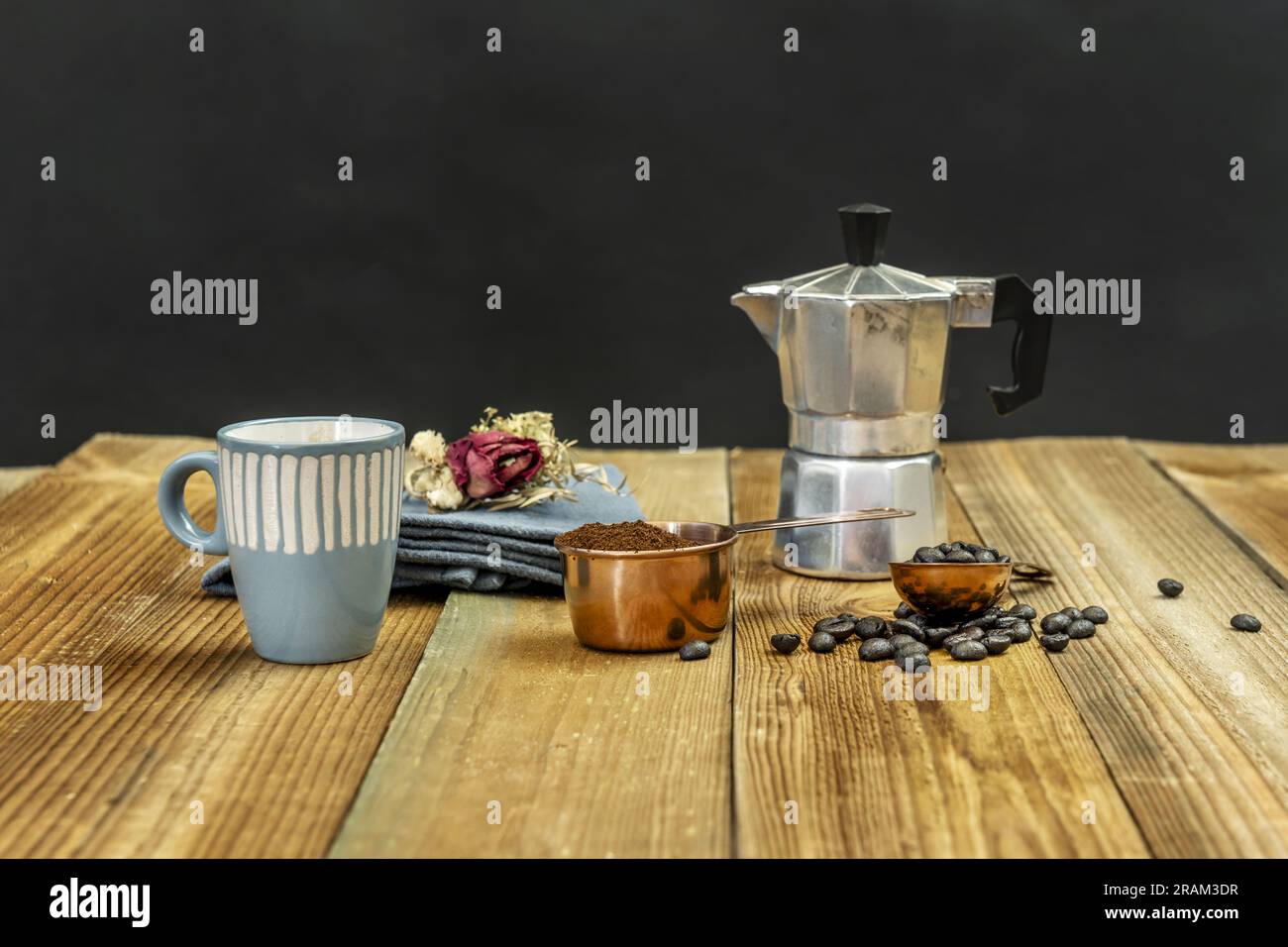 A still life with a vintage coffee maker with two services, ground ...