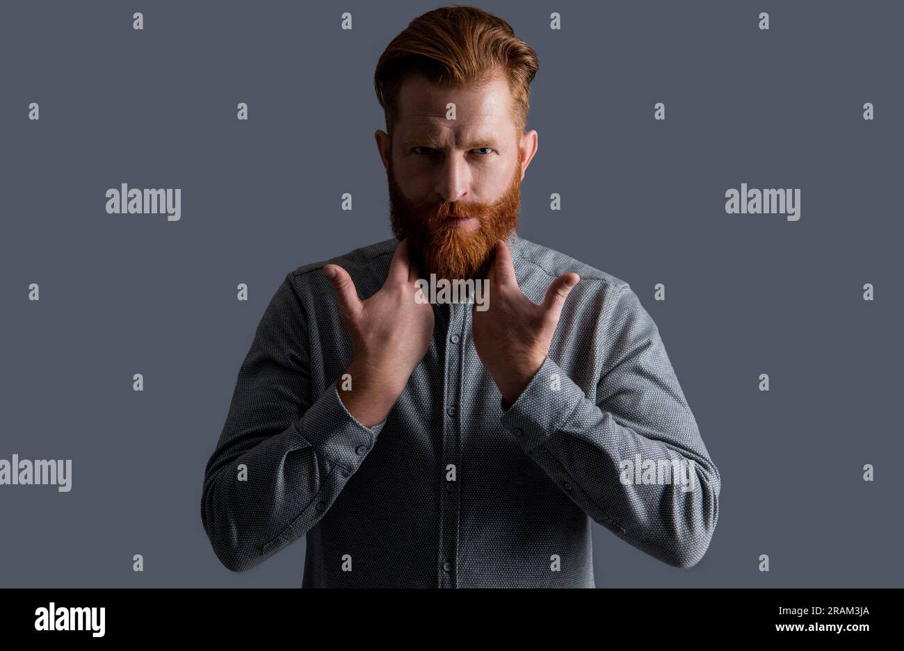 Irish man touching beard. Bearded man with stylish beard and mustache ...