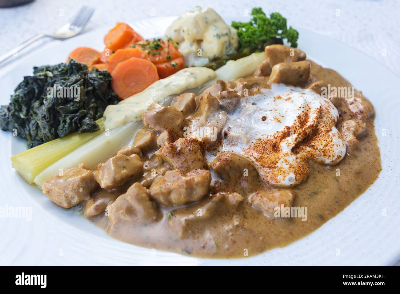 Zurich style veal meat stew with diverse season vegetables: asparagels ...