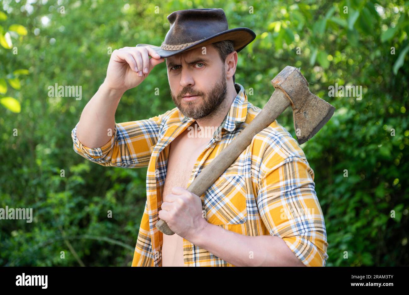 image of cowboy with axe. cowboy with axe. cowboy with axe wearing ...