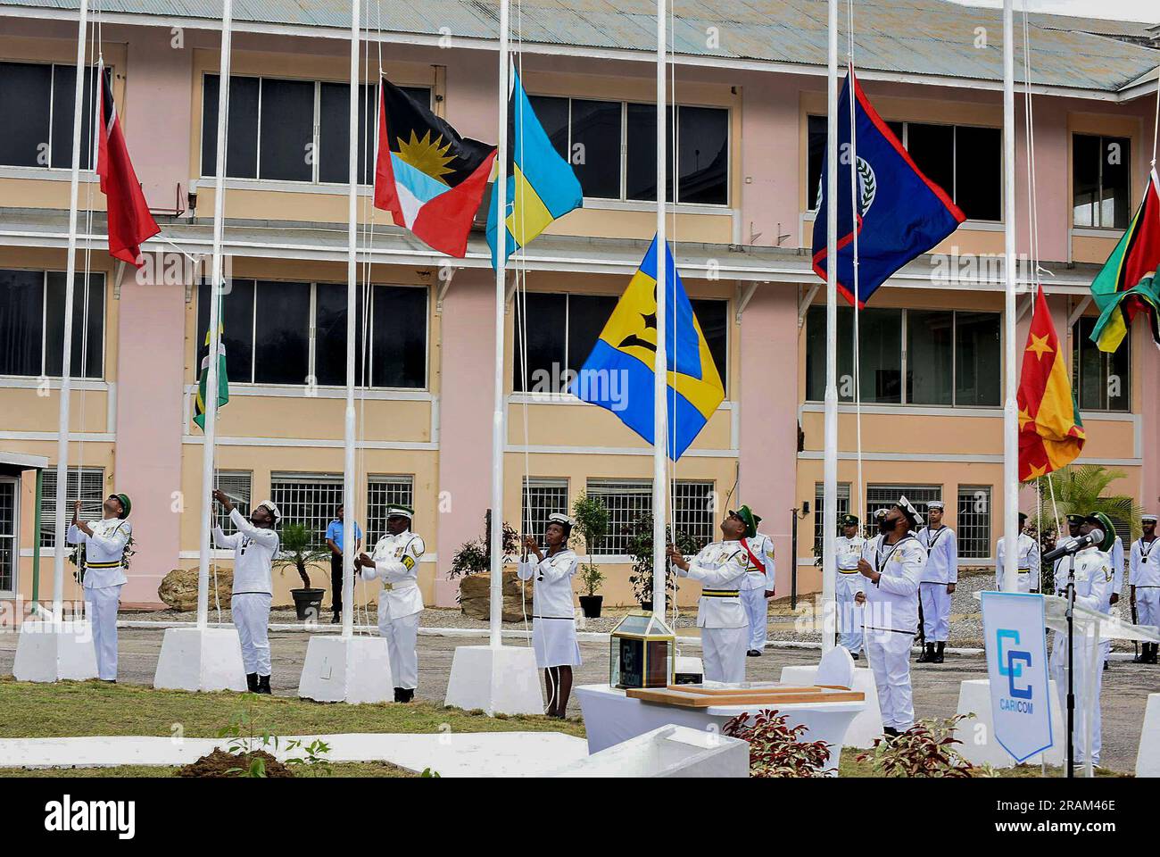 Members of the Trinidad and Tobago Defence Force raise the flags of CARICOM nations during a ...