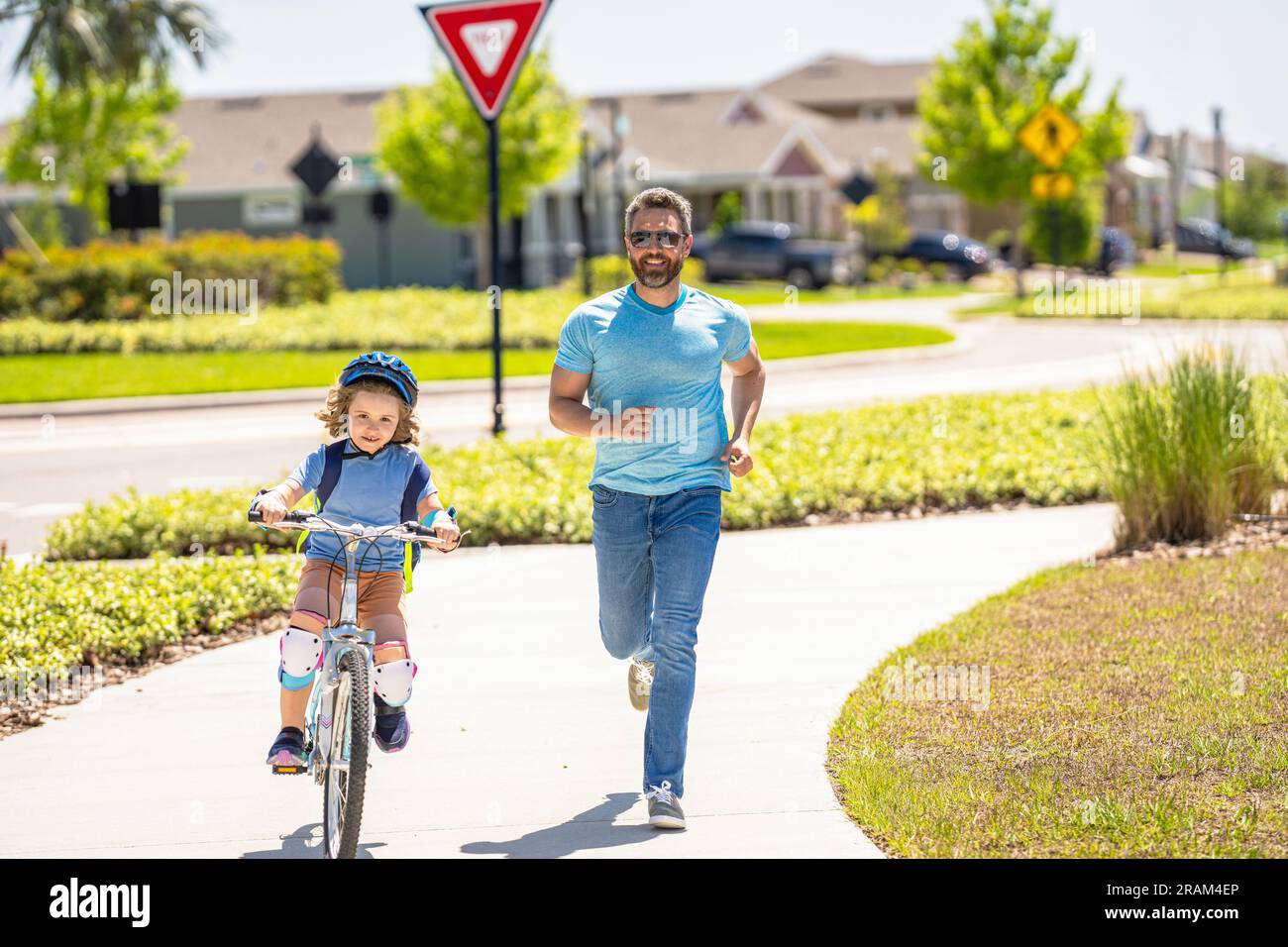 father and son on bicycle at fathers day. active father setting a ...