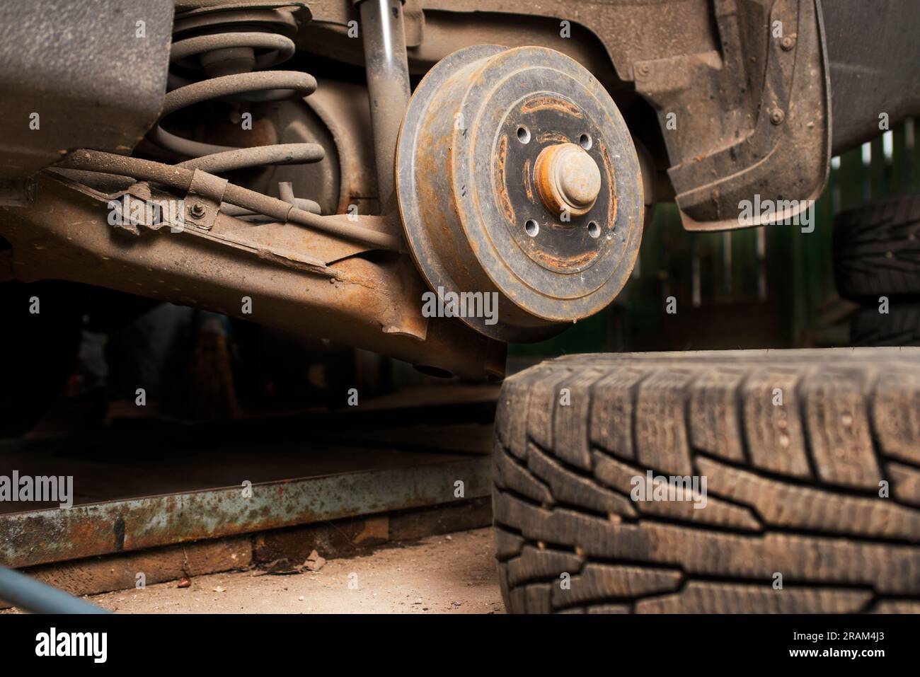 Car on tire mounting with removed wheel. Wheel hub closeup Stock Photo ...