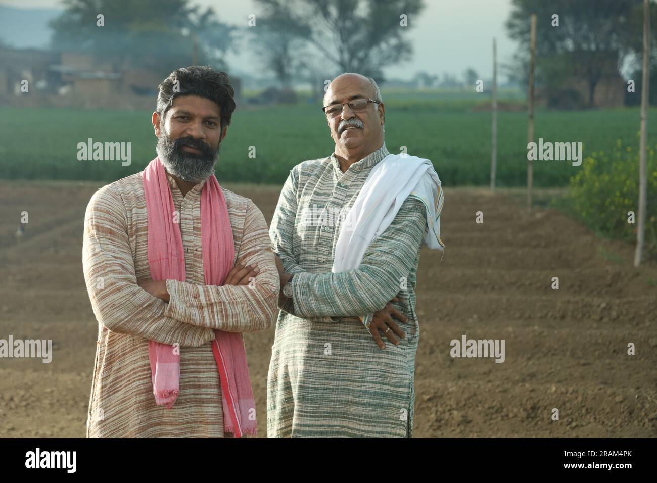 Farmers father and son standing together in the mustard crops hi-res stock photography and ...