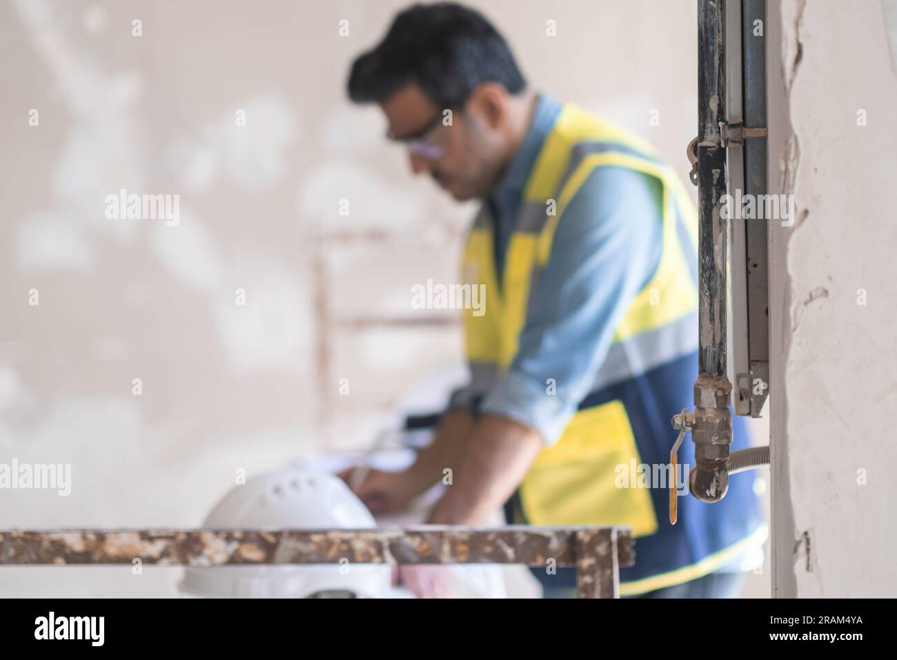 construction specialist in professional uniform working with drawings documentation Stock Photo ...