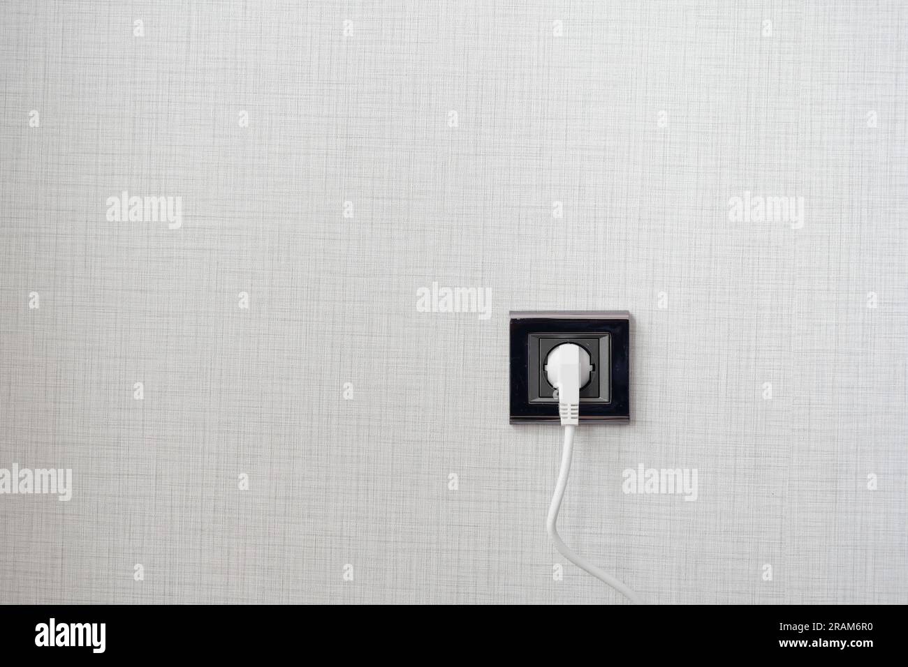 white color power cord cable plugged into wall Stock Photo - Alamy