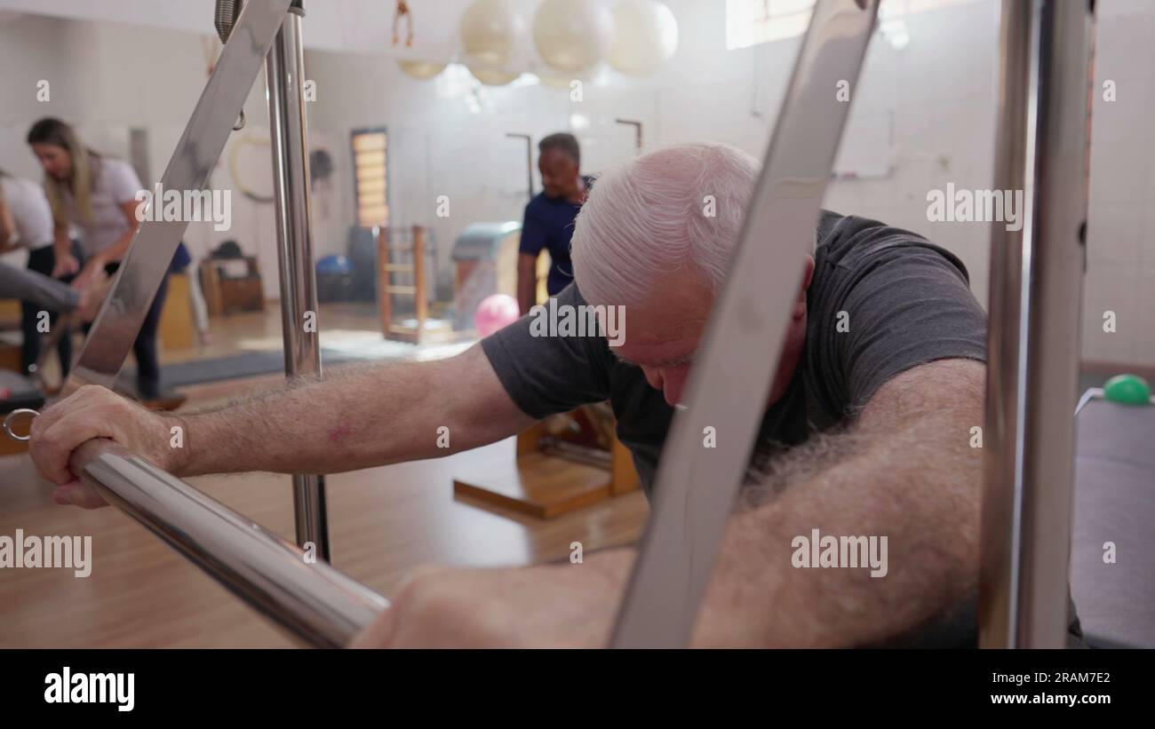 Senior man exercising with Pilates Machine. Old age workout routine ...