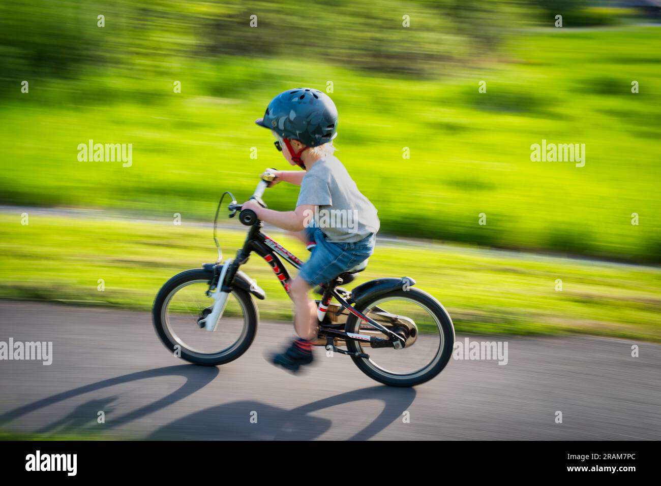 A young boy testing his new bike Stock Photo - Alamy