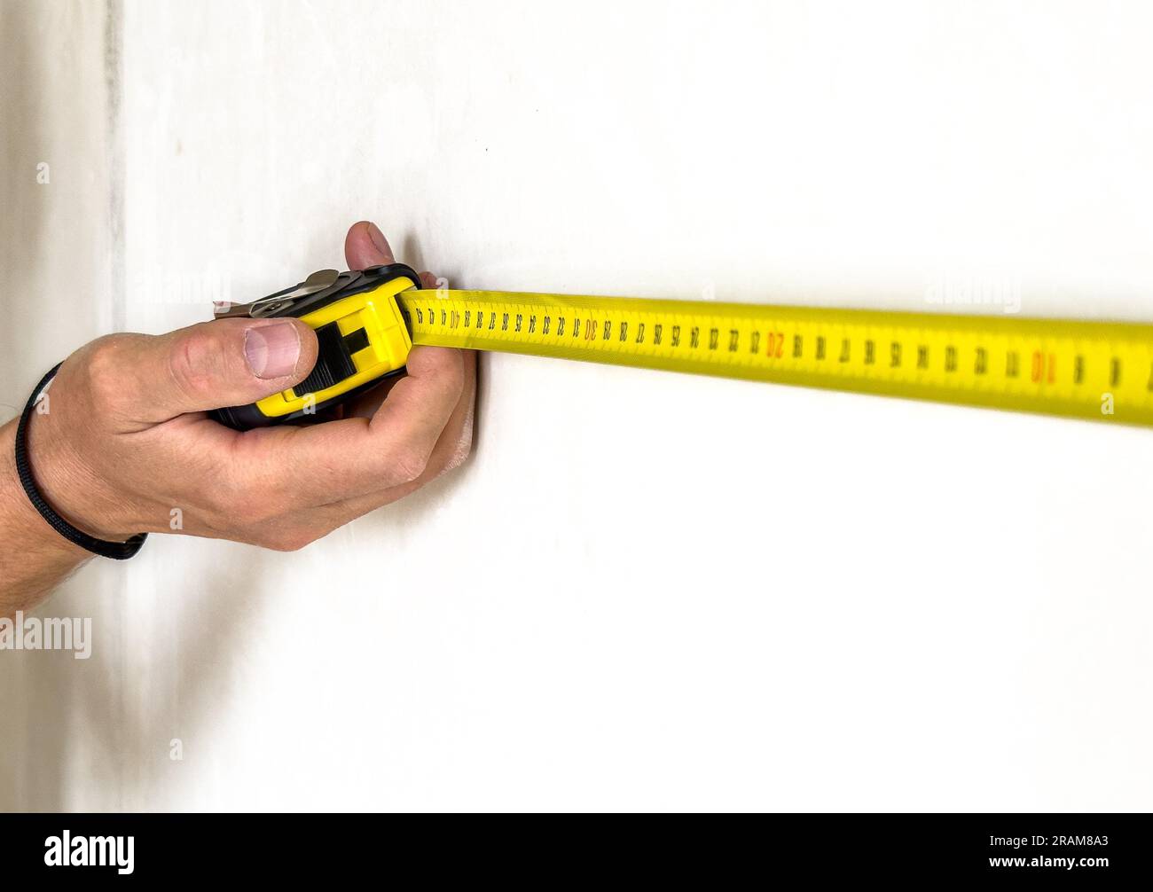 Hand holding measuring tool, instrument for home wall measurement Stock ...