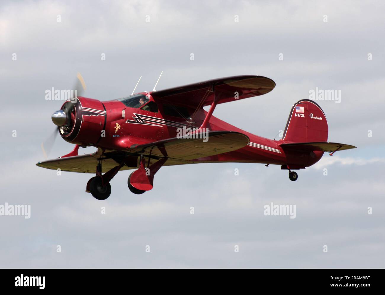 A Beechcraft D17S Staggerwing biplane departing Headcorn Aerodrome Kent ...