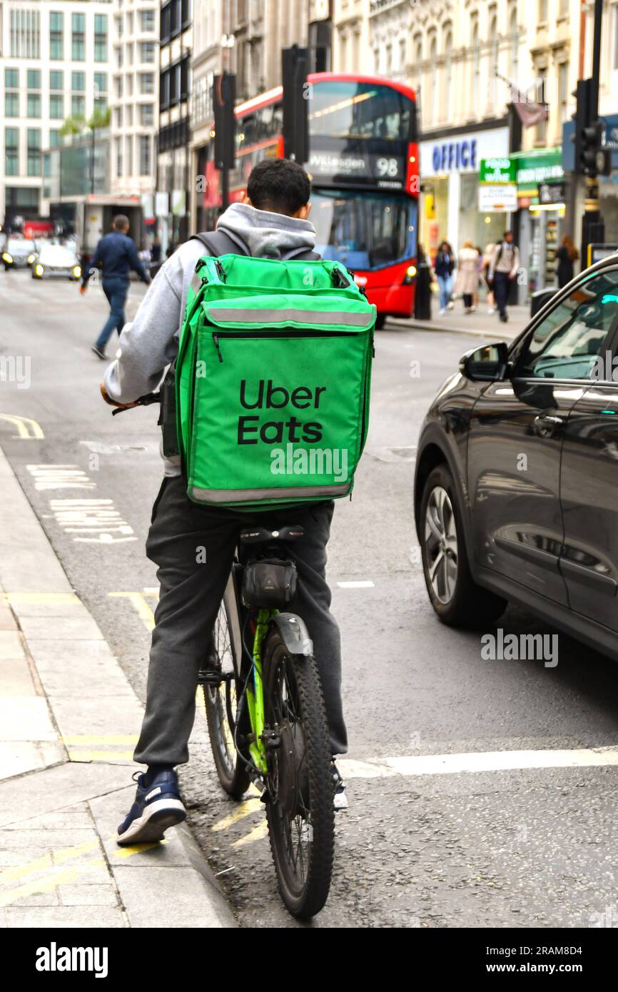 London, England, UK - 28 June 2023: Cyclist carrying an insulated ...