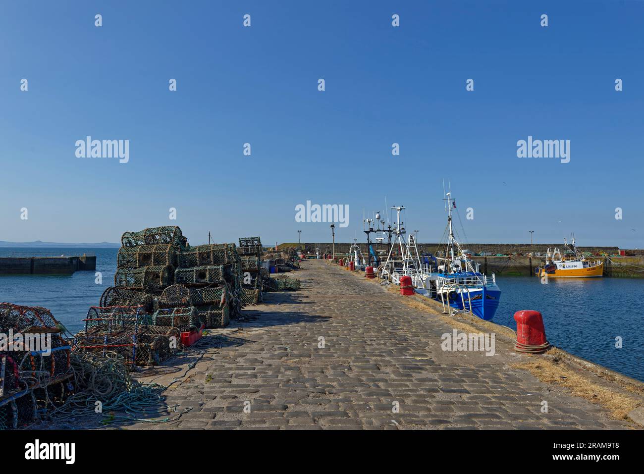 Looking down the traditional Stone Quay of Port Seton with Crab and ...