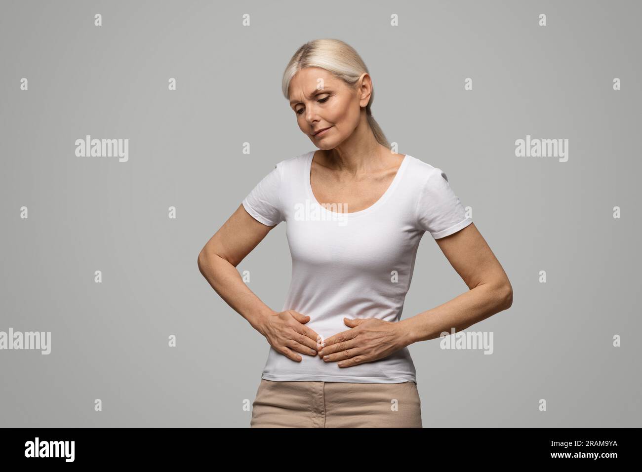 Stomach Pain. Sick mature woman suffering from acute abdominal ache ...