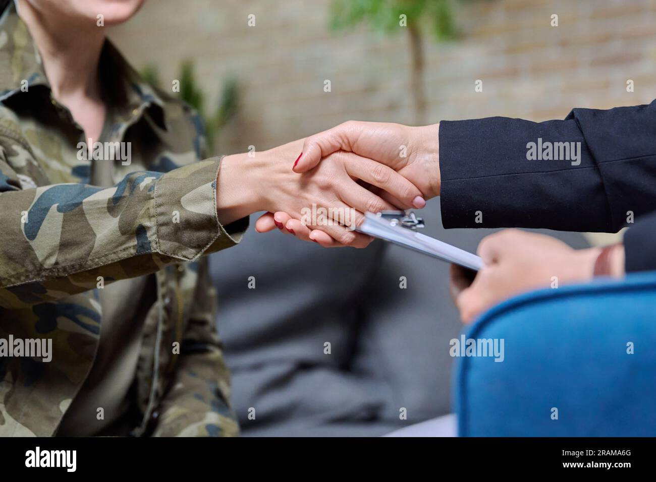 Middle-aged military woman talking with professional psychologist ...