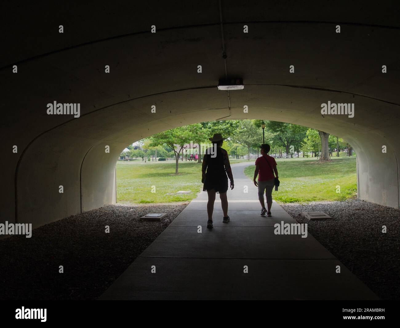 Two women walk through the College Avenue underpass at Baker Park in ...