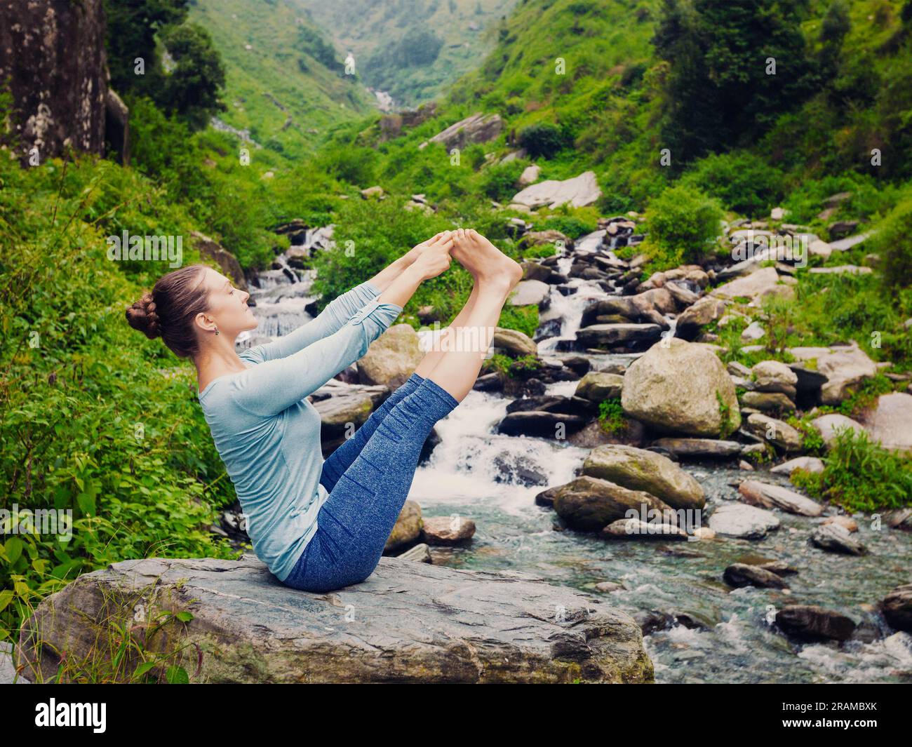 Woman doing Ashtanga Vinyasa Yoga asana outdoors Stock Photo - Alamy