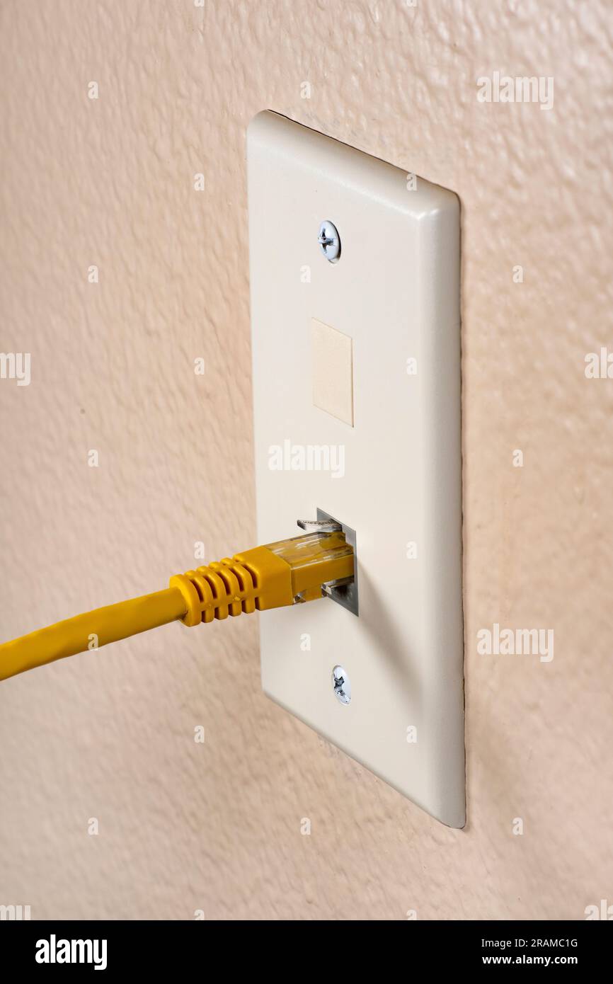 An ethernet cable RJ45 pluggest into home network socket Stock Photo ...