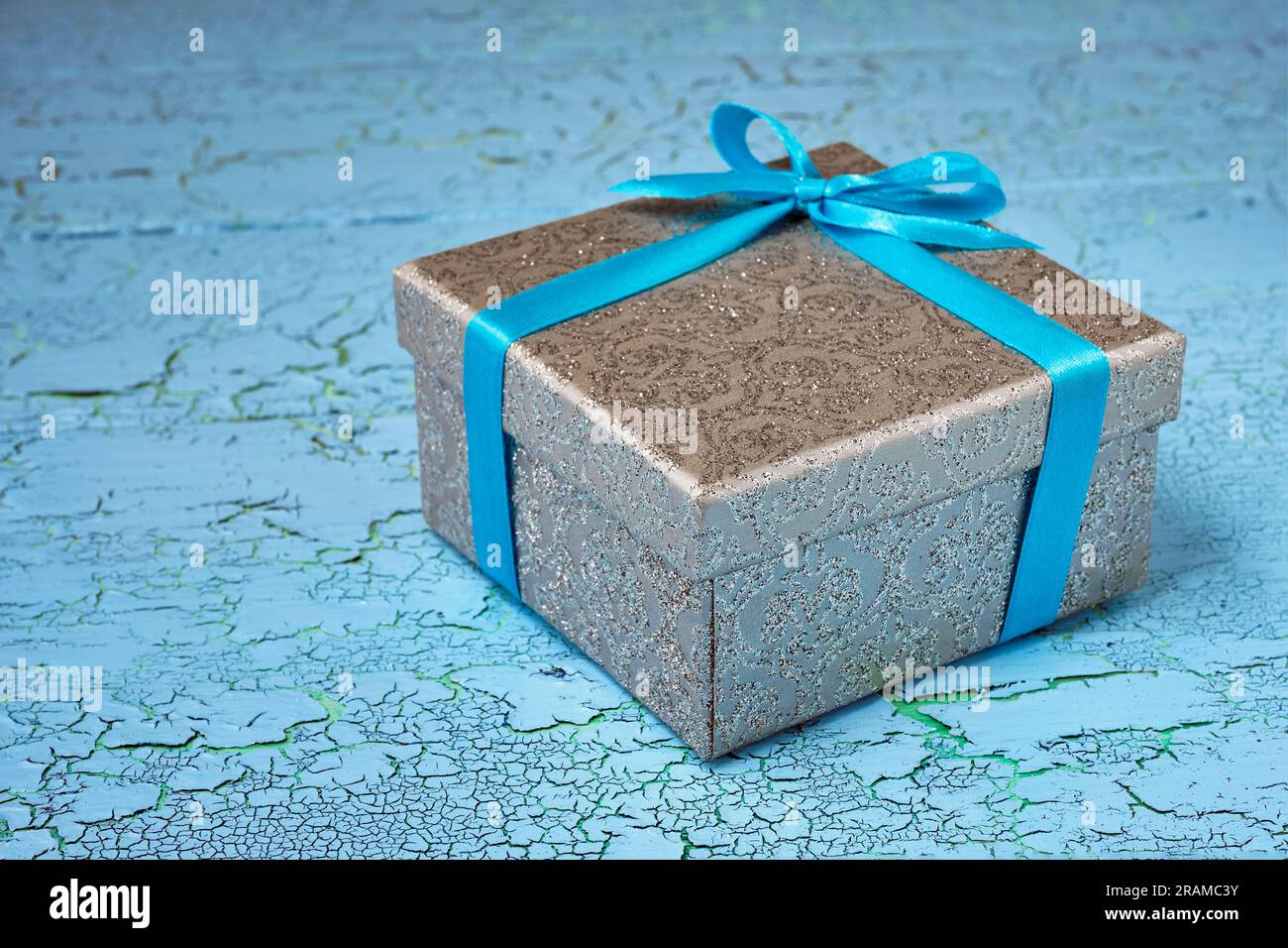 Gift box with blue ribbon Stock Photo - Alamy