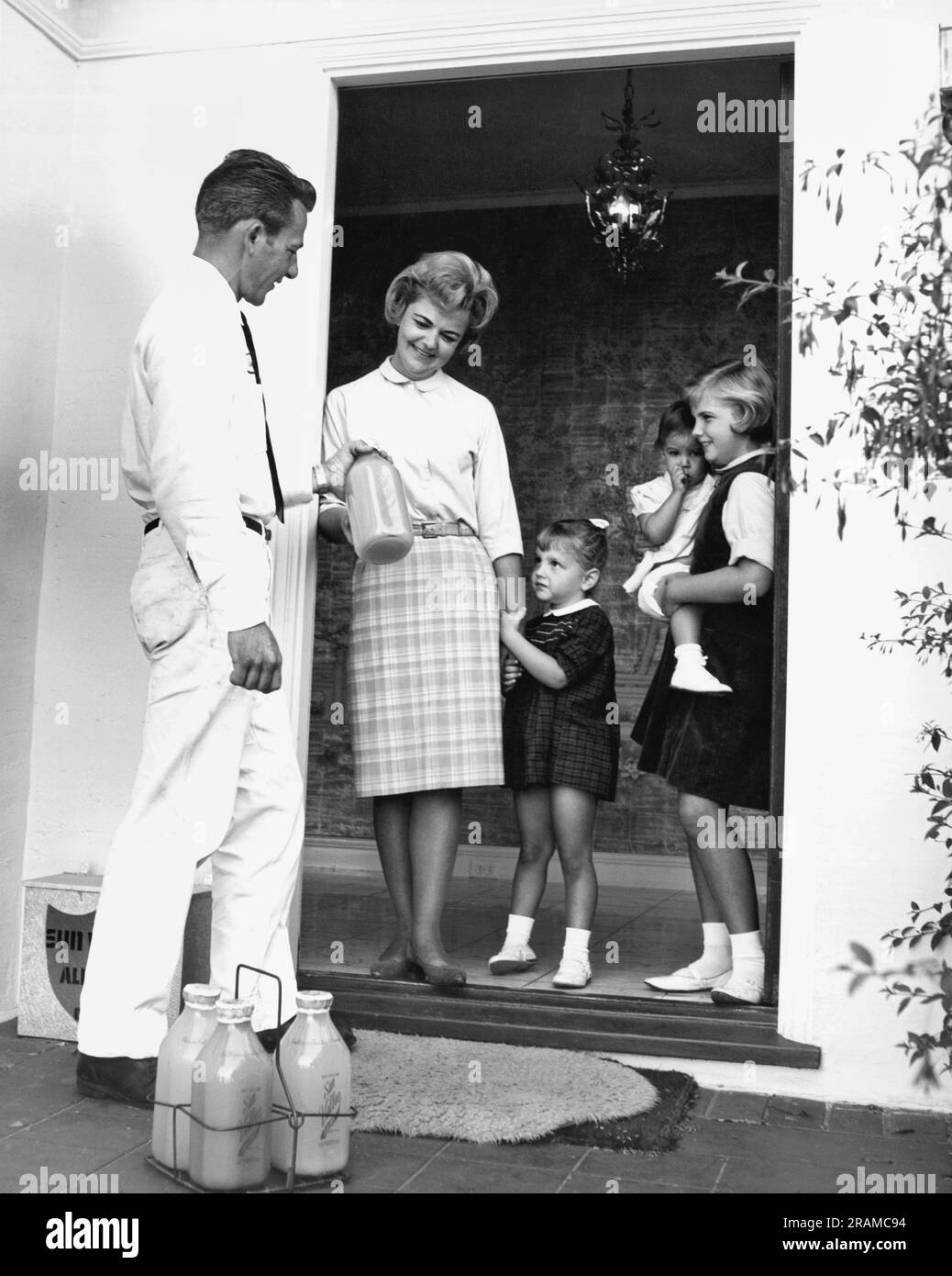 California: c. 1955 A Sun Valley Dairy milkman delivers half gallons of ...