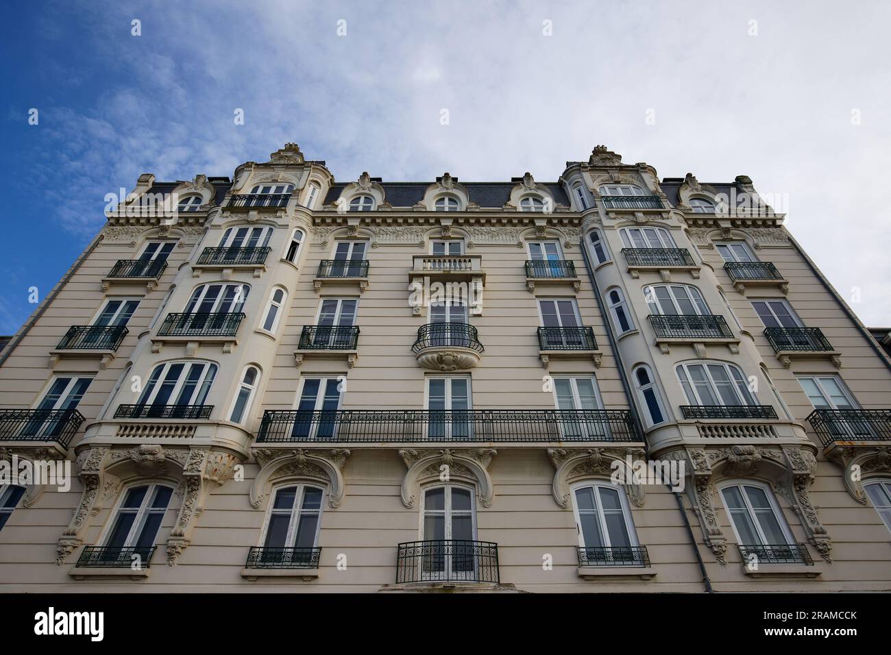 The facade of traditional French house with typical balconies and ...