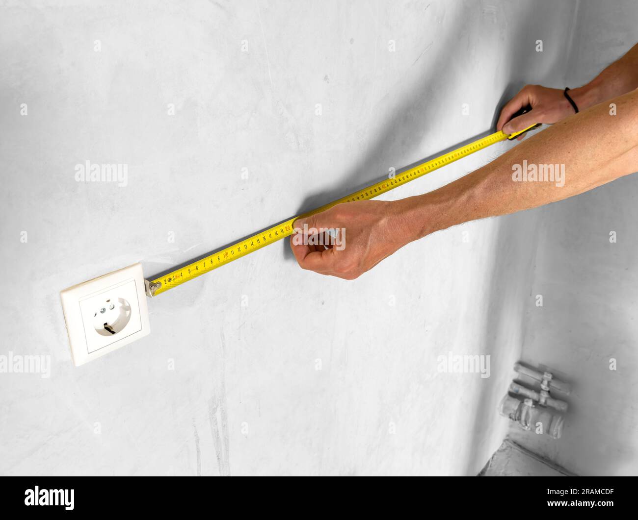 Hand holding measuring tool for apartment wall measurement Stock Photo ...