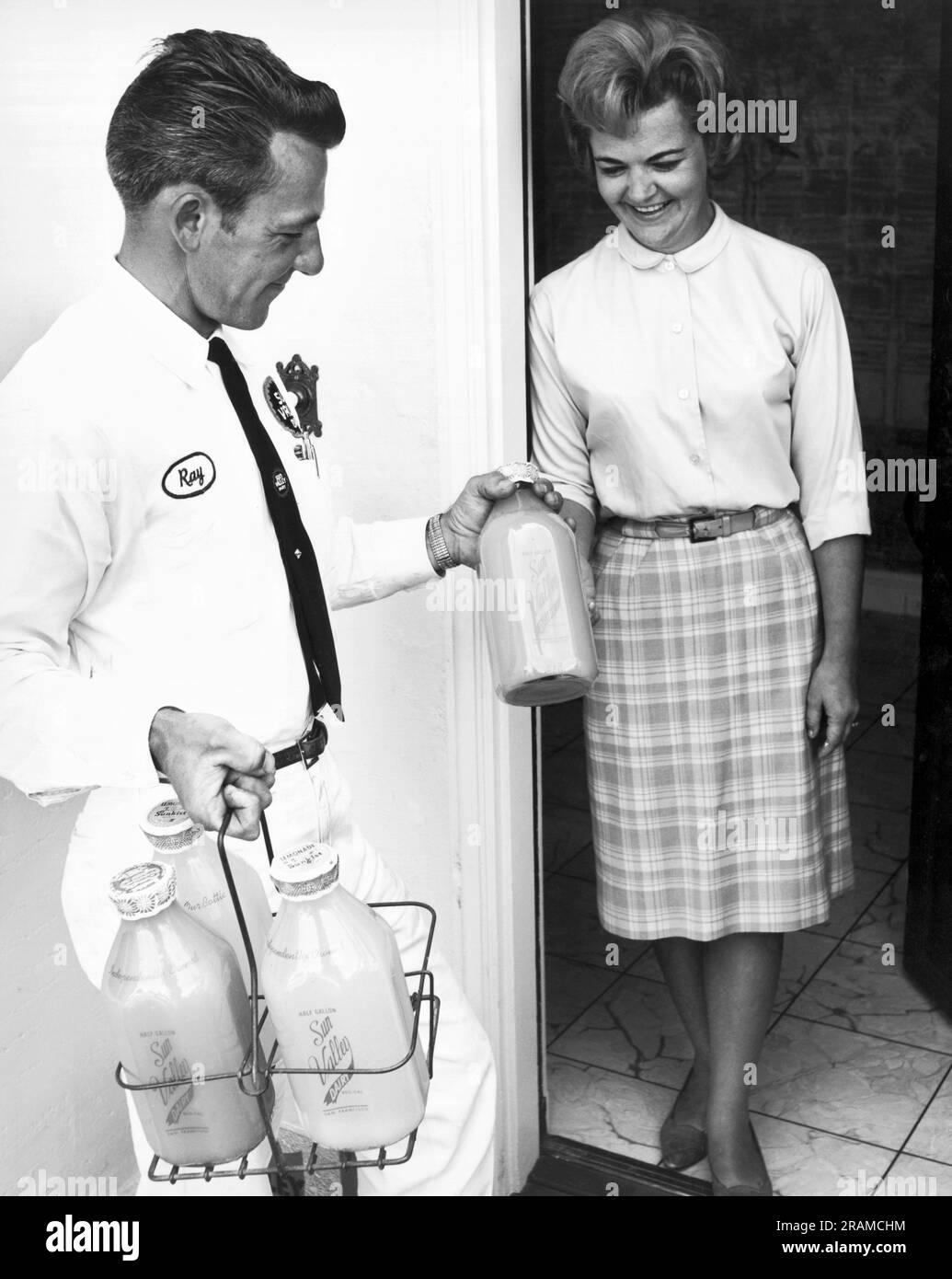 California: c. 1955 A Sun Valley Dairy milkman delivering milk and ...