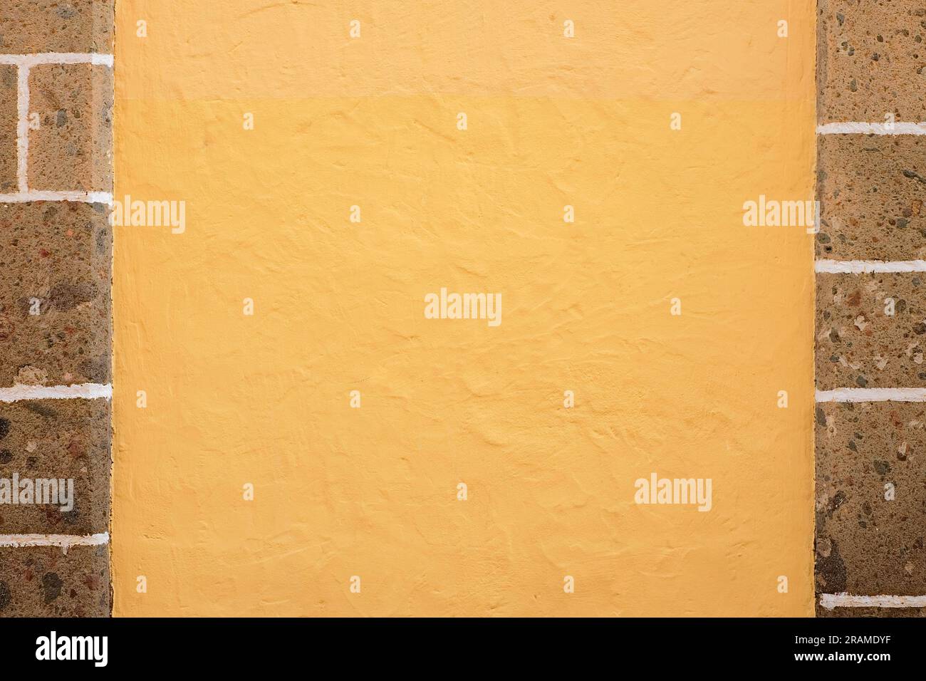 Yellow wall with stone margins, background with space for text, banner ...