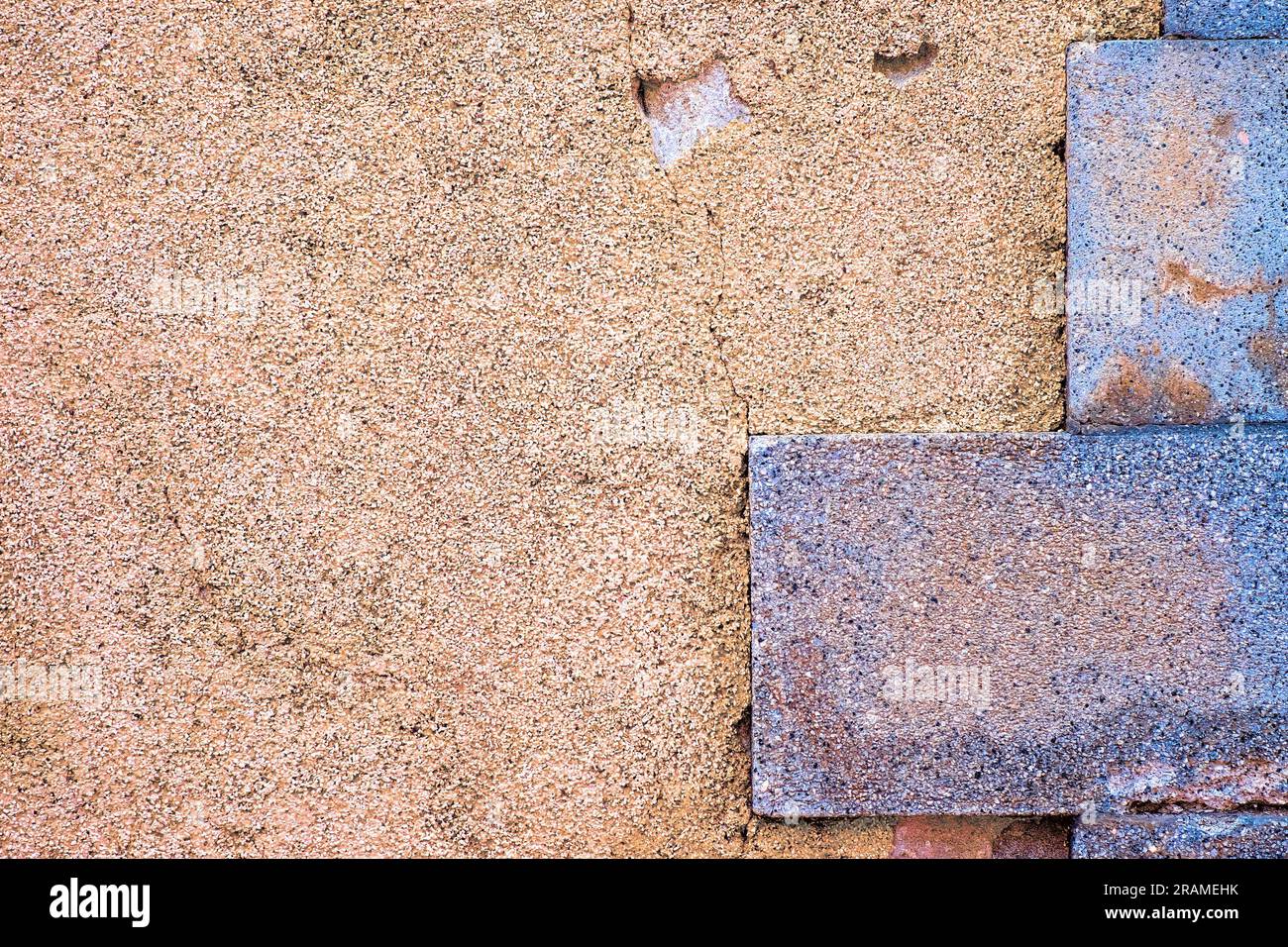 Weathered wall with pale pink plaster and gray stone blocks Stock Photo ...