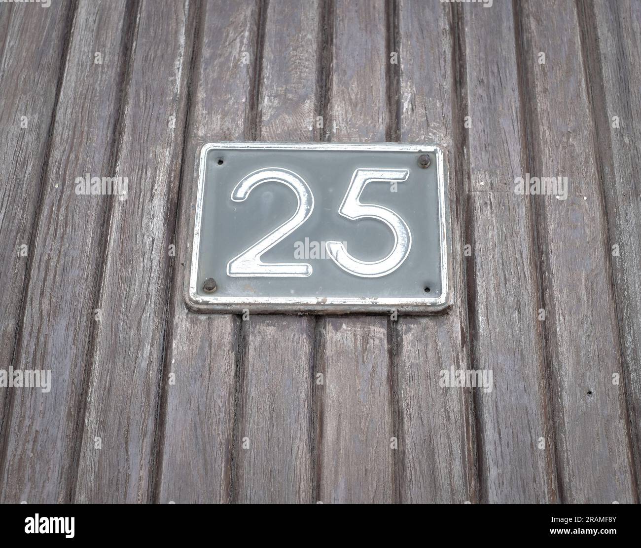 25, number twenty-five, pale blue plate on vertival planks Stock Photo ...