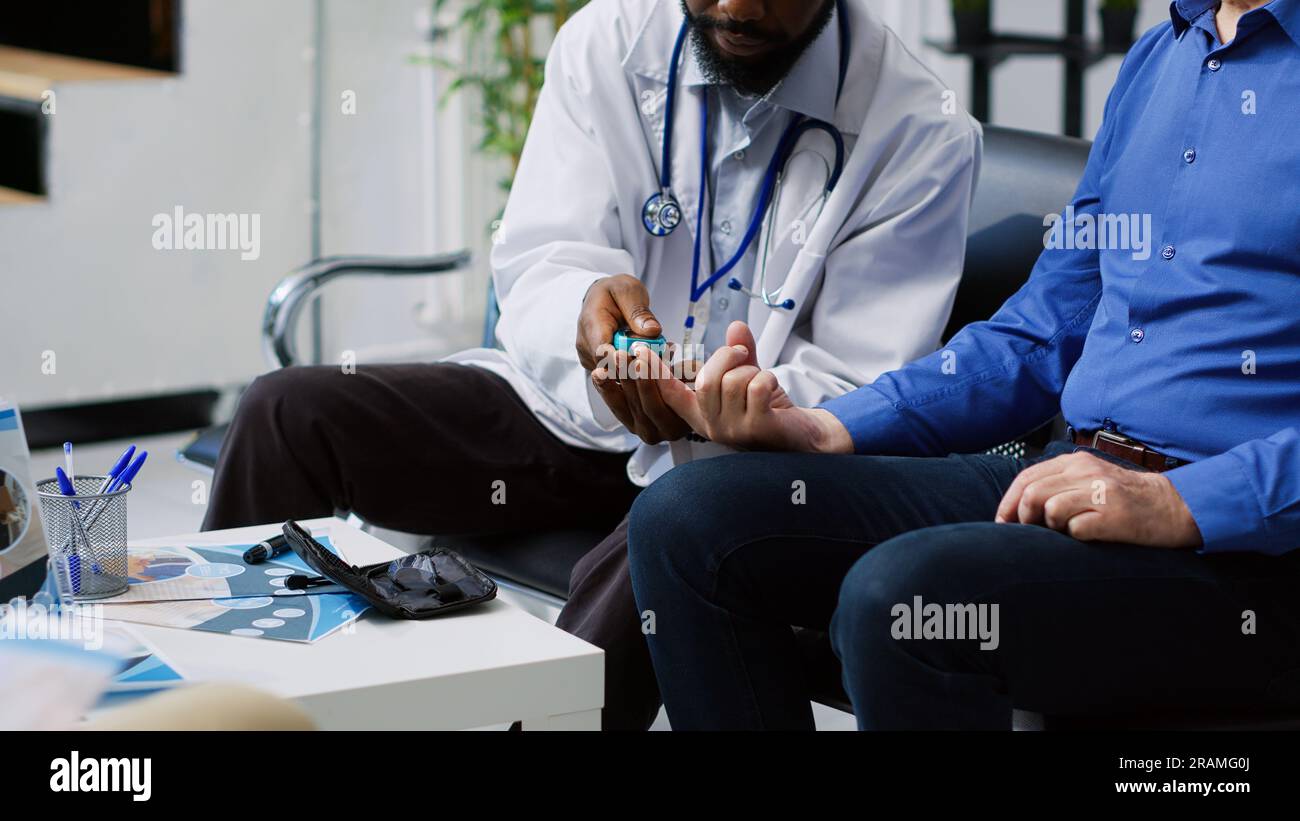 Physician doing insulin level measurement with medical instrument to ...