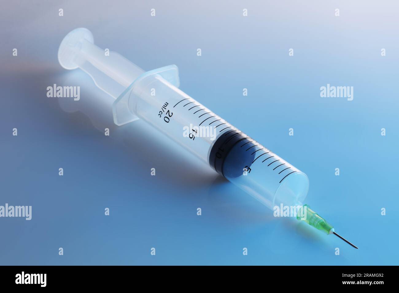 Syringe on clinical blue surface with shadow Stock Photo - Alamy