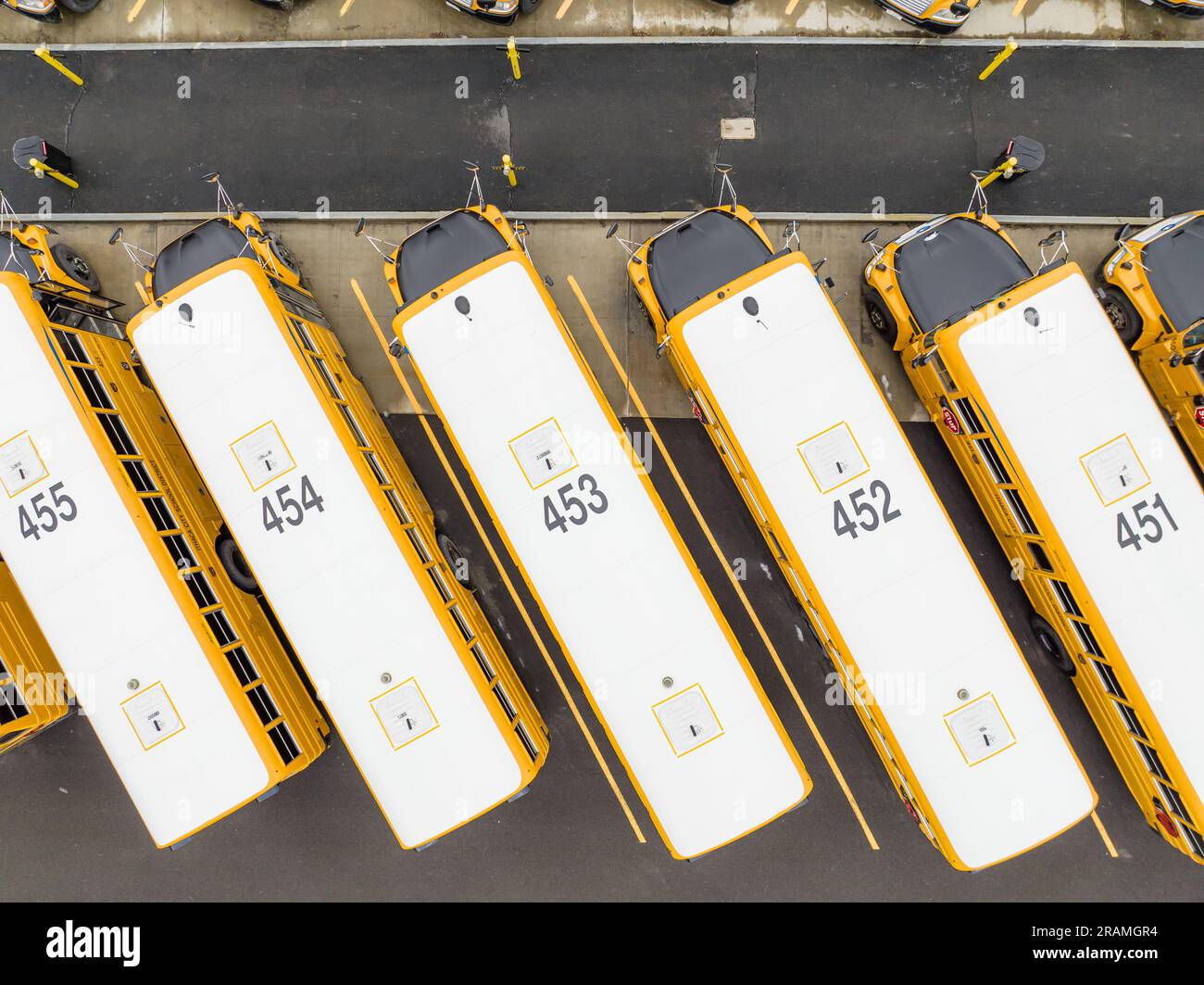 Aerial view of yellow school buses in a concrete parking lot Stock ...